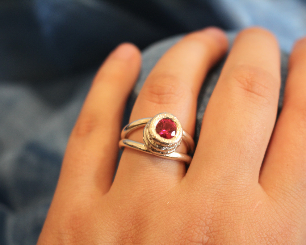 Here's a uniquely designed sterling silver and lab grown ruby ring.